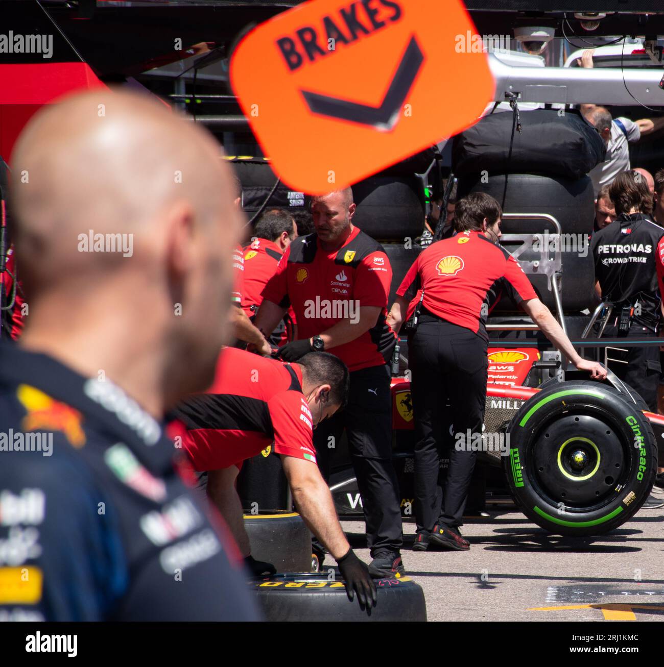 Red Bull's staff member looking Ferrari's stand Stock Photo - Alamy