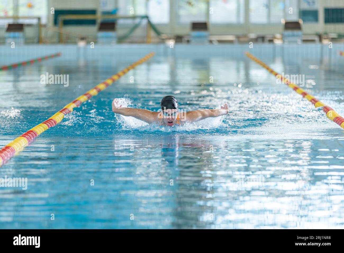 Female competitive swimmer moving through the water performing the ...