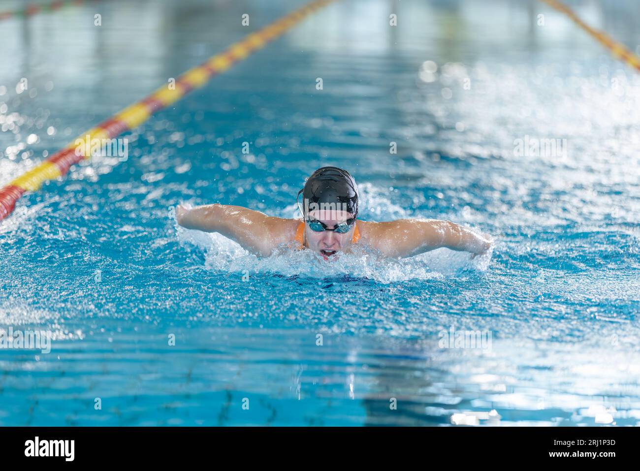 Female competitive swimmer moving through the water performing the ...