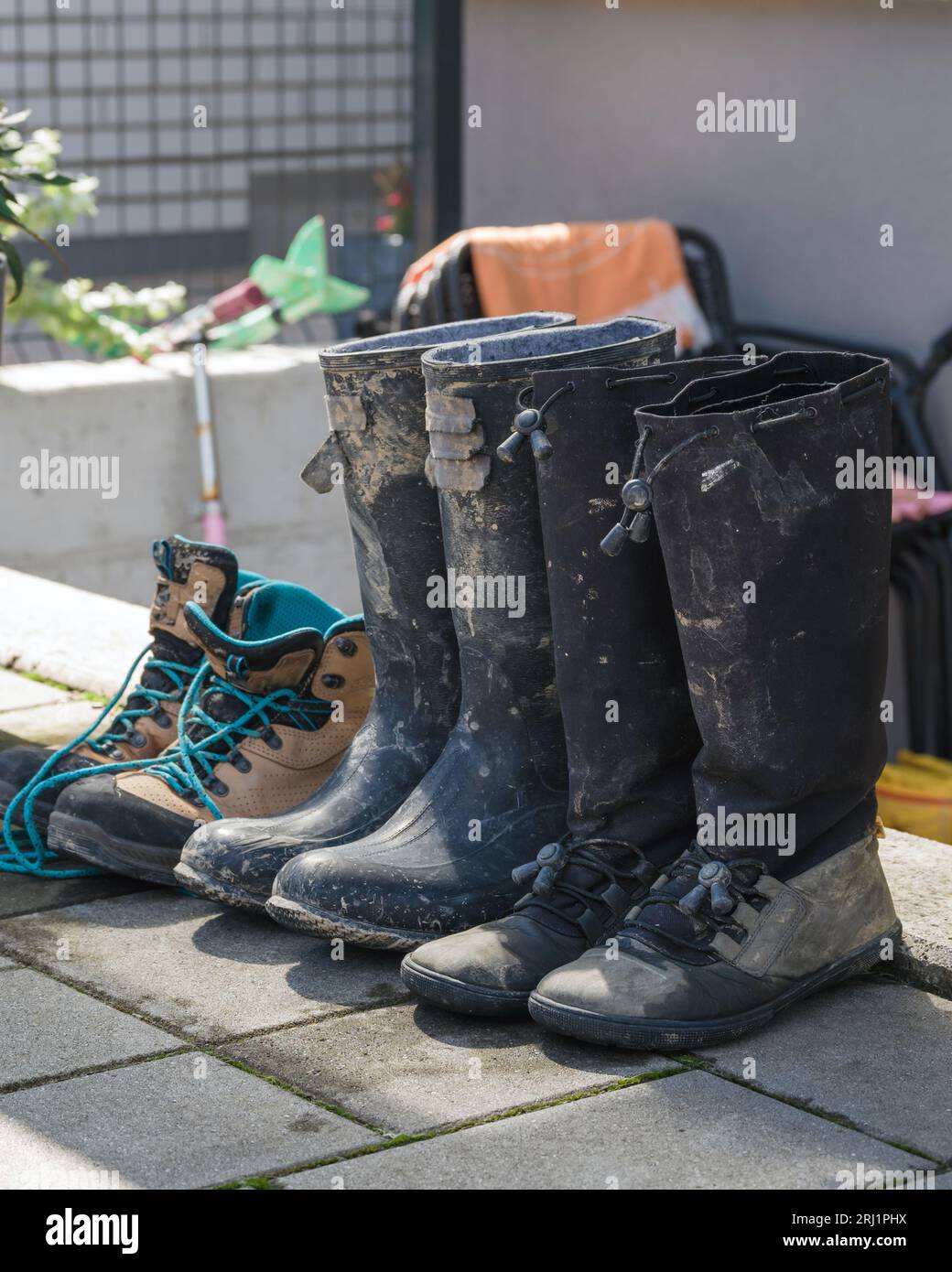 Muddy boots after floods in the city streets after heavy rain. Severe ...