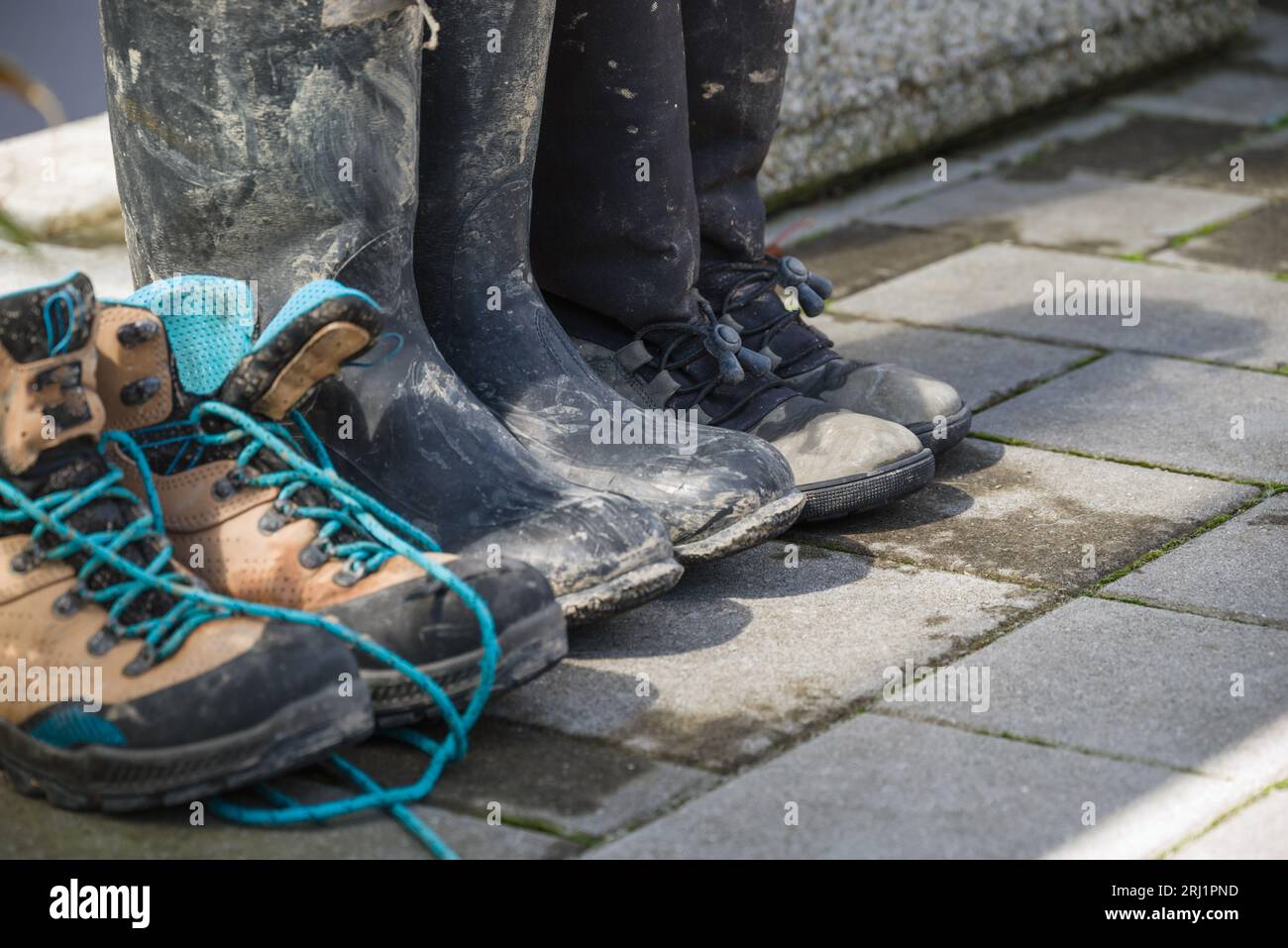 Muddy boots after floods in the city streets after heavy rain. Severe ...