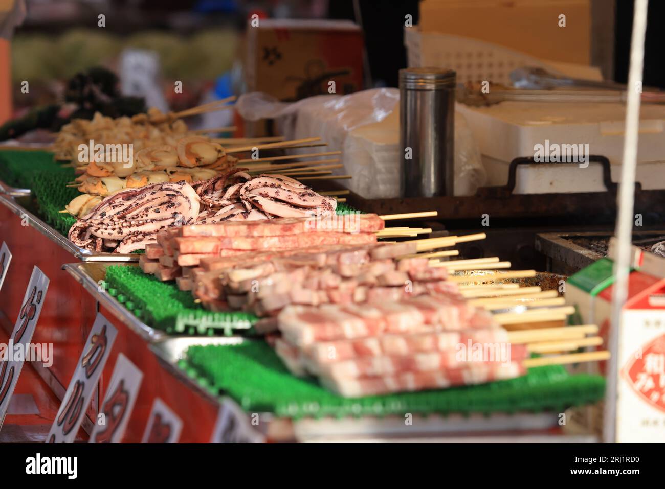 skewer pork and seafood in japanese food stall in the food market of ...