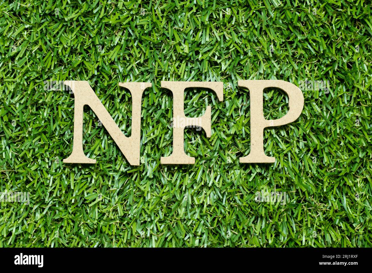 Wood alphabet letter in word NFP (Abbreviation of Nonfarm payrolls) on ...