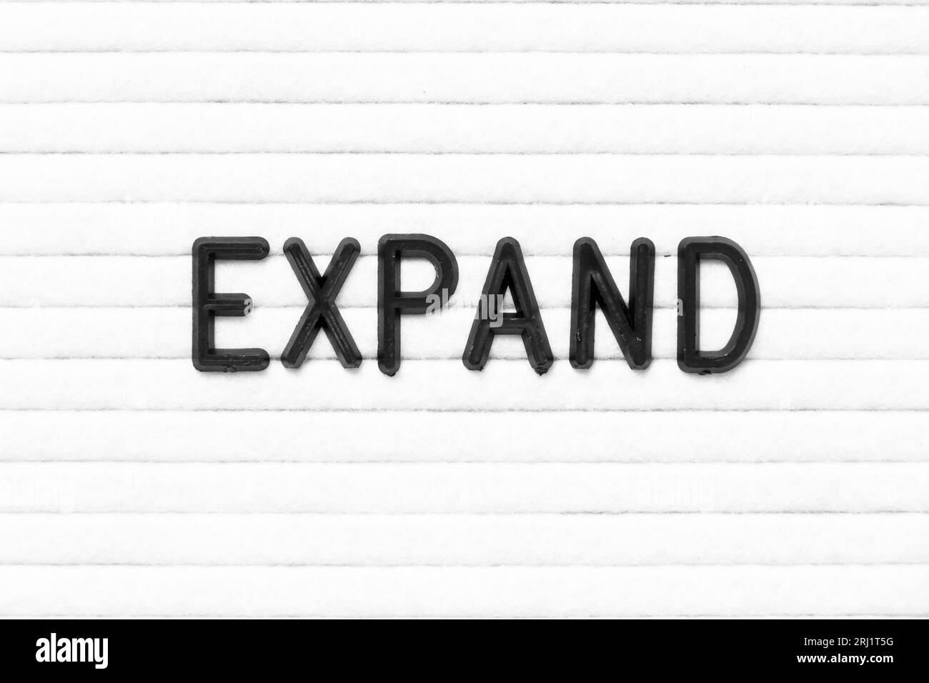Black color letter in word expand on white felt board background Stock ...