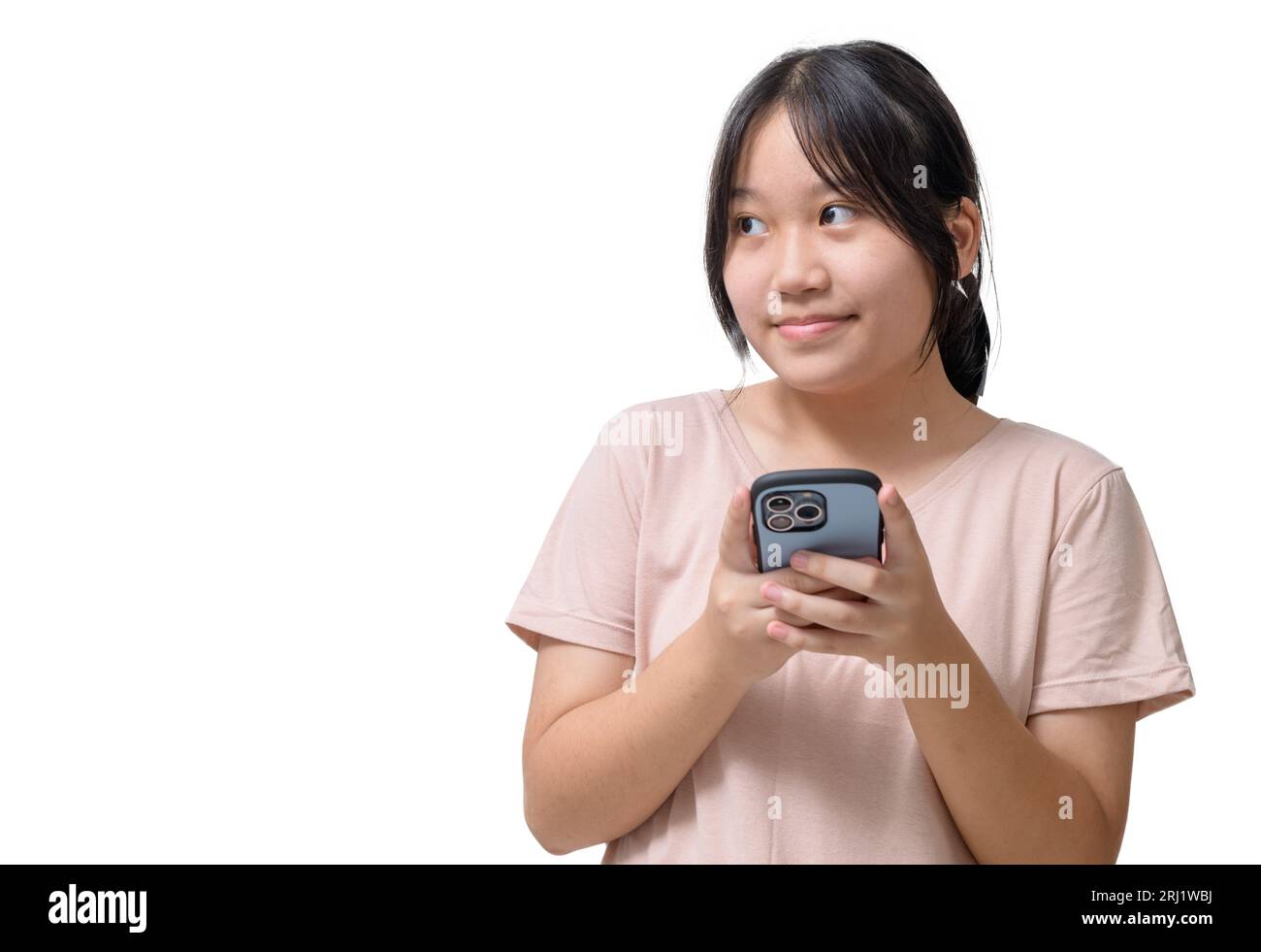 Portrait of cute asian girl look left at copy space, holding smartphone ...