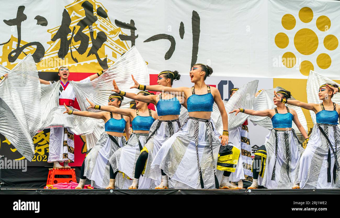 Japanese teenage women Yosakoi dance team in silver and blue costumes ...