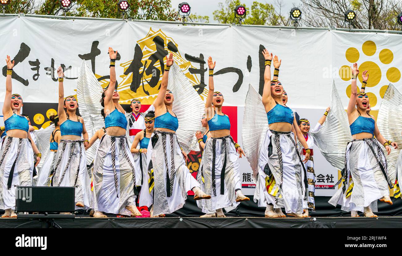 Japanese teenage women Yosakoi dance team in silver and blue costumes ...