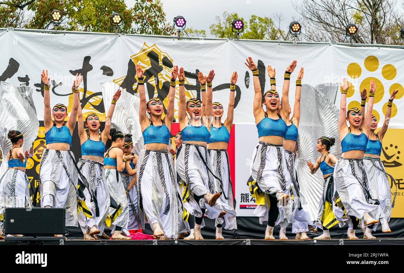 Japanese teenage women Yosakoi dance team in silver and blue costumes ...
