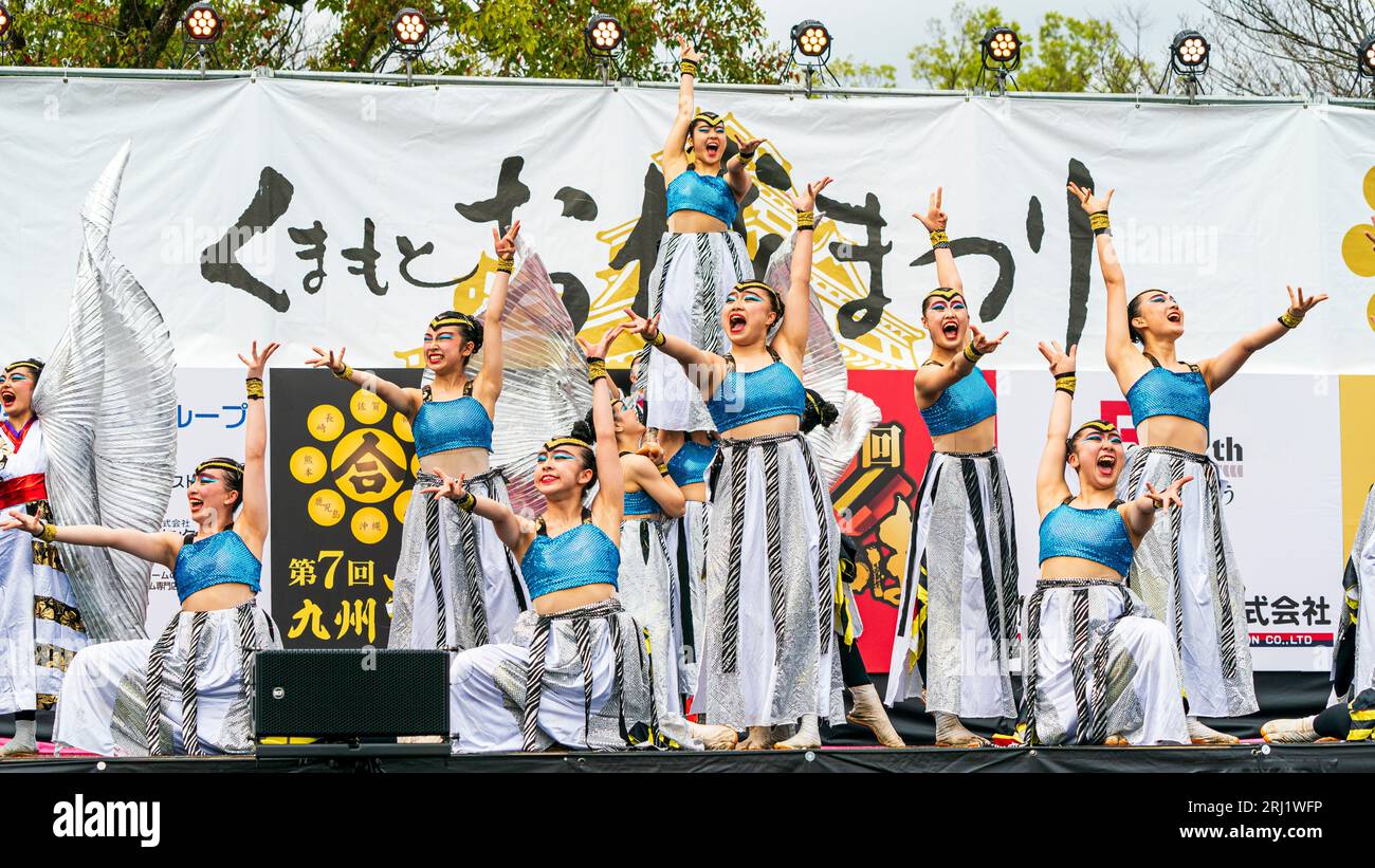 Japanese teenage women Yosakoi dance team in silver and blue costumes ...
