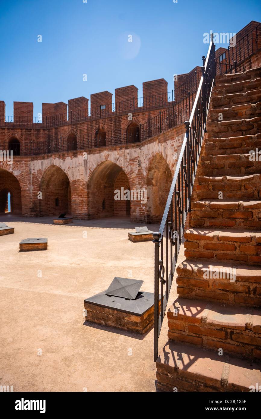 View of Alanya Red Tower in Antalya with orenge bricks, on bright blue ...