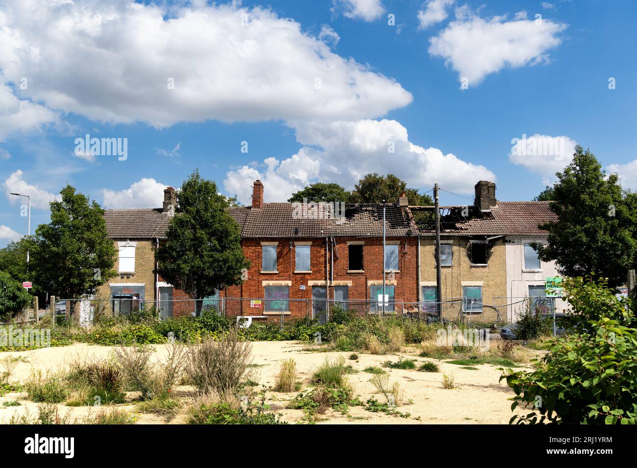A row of burnt out and derelict terraced houses in the North of England ...