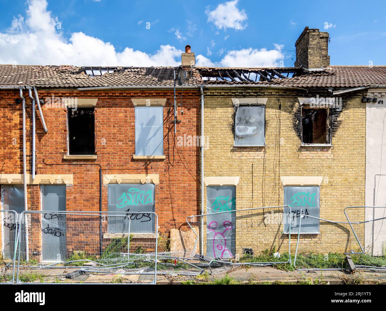 A row of burnt out and derelict terraced houses in the North of England ...