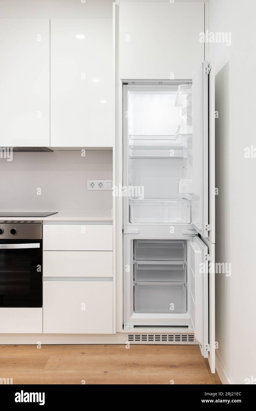 Photo of a modern kitchen with sleek white cabinets and empty ...