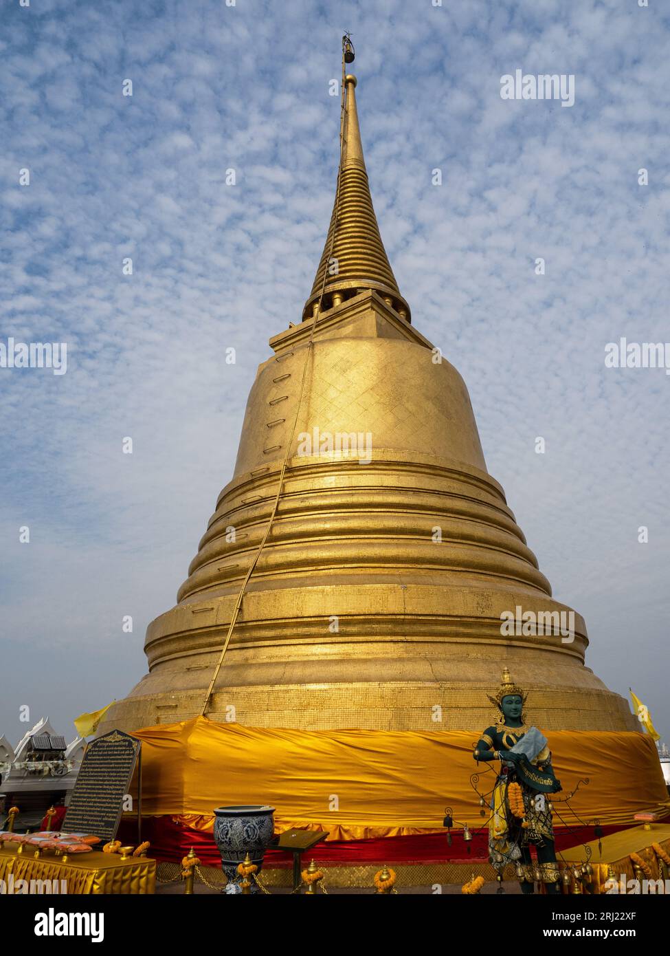 Stretching into the sky, the temple's pinnacle, a radiant golden spire ...