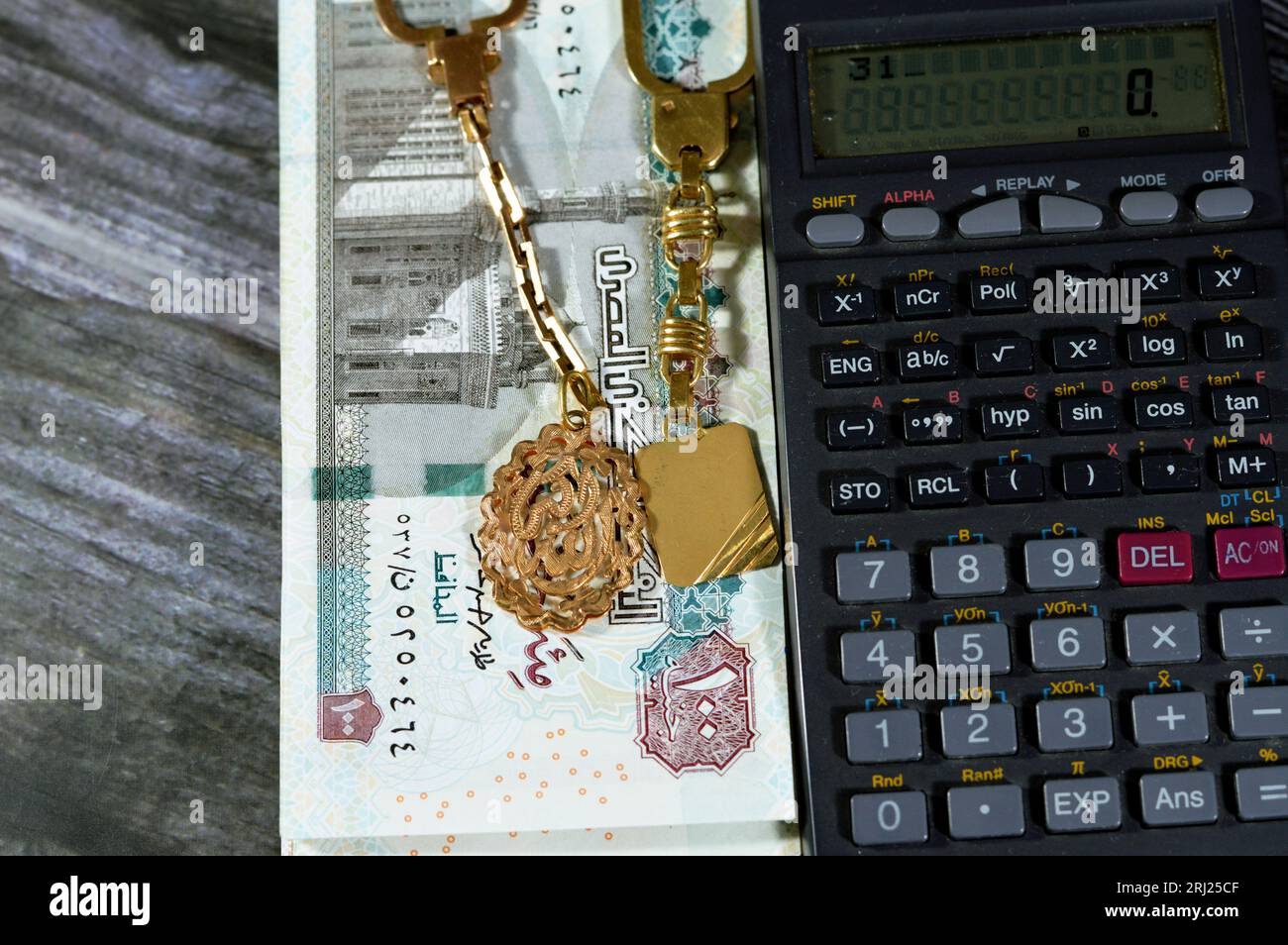 Calculator and golden keyring medals made of gold karat 18 with Arabic ...