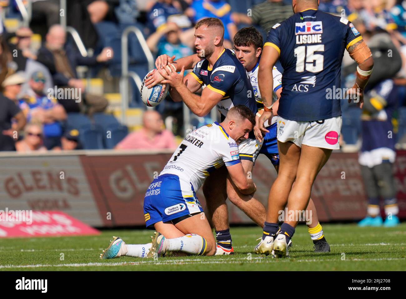 Jordy Crowther #36 of Warrington Wolves forces a loose carry by Jarrod ...