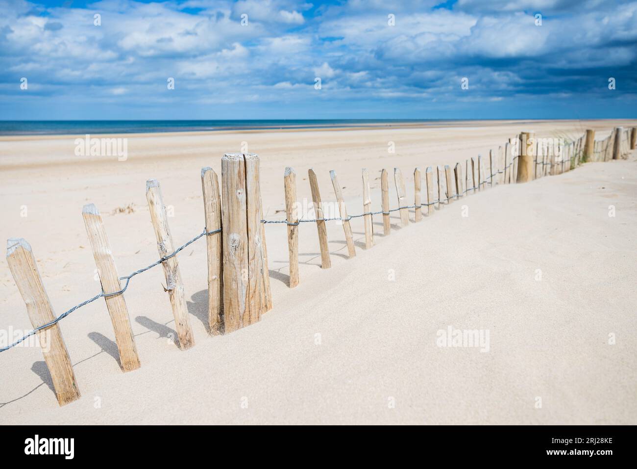 A small beach fence pictured between the main beach and sand dunes at ...