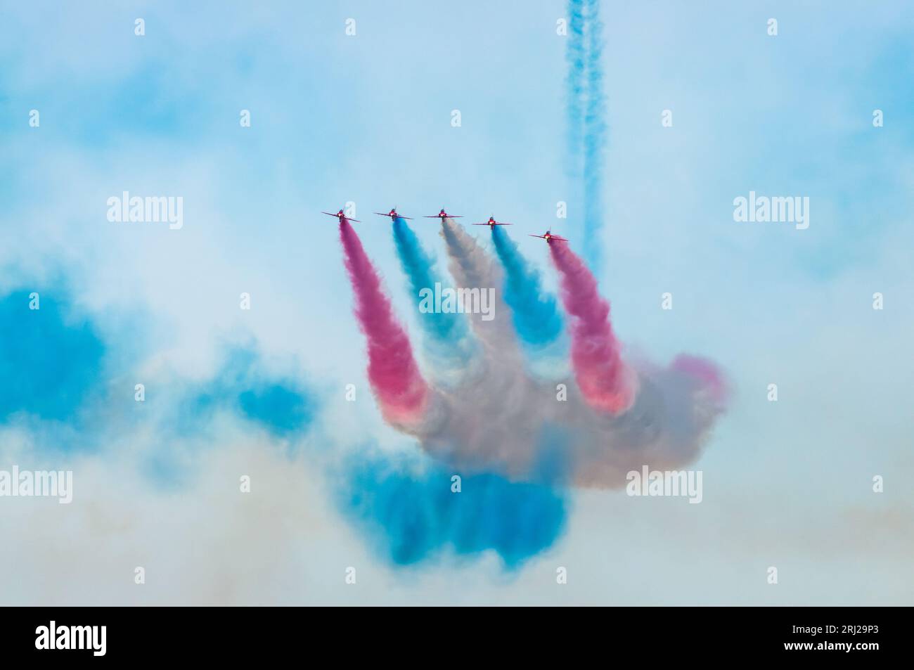 The world famous RAF display team The Red Arrows release red, blue and ...