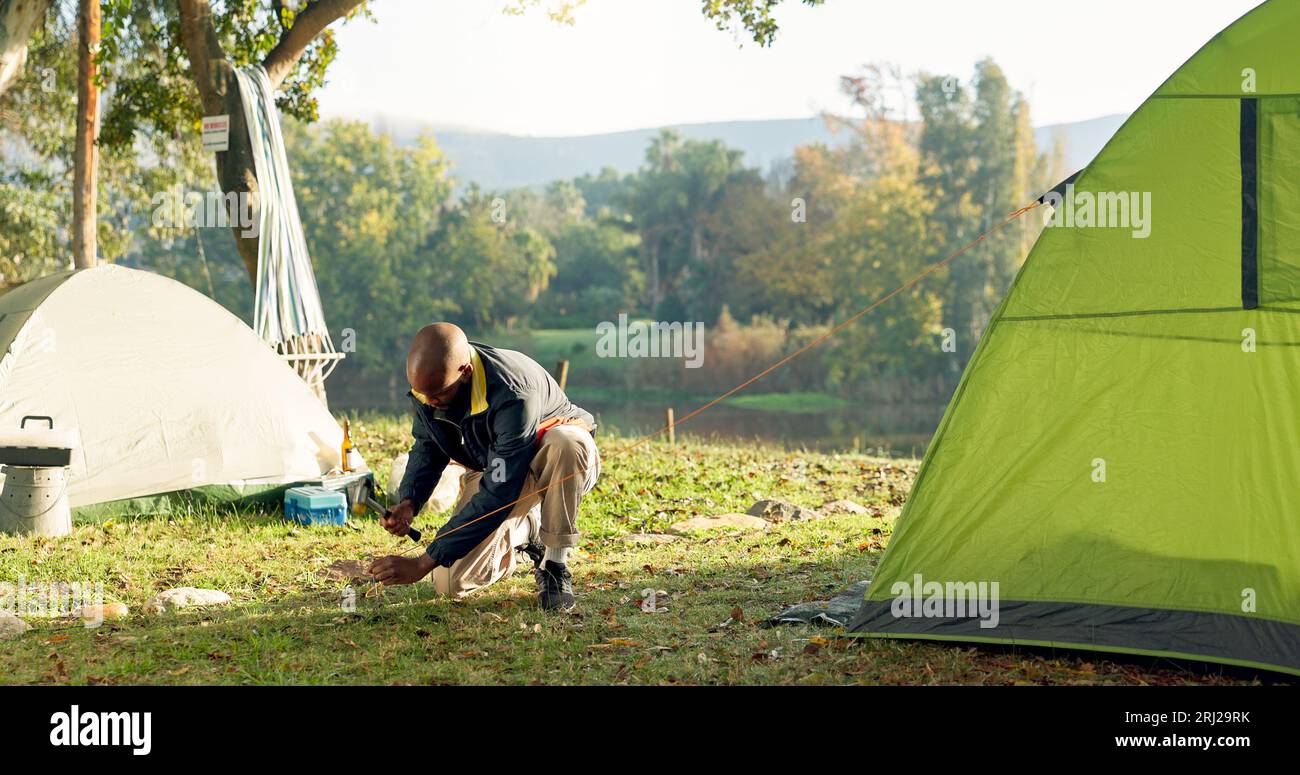 Camping, tent and black man setup in woods for shelter on outdoor ...