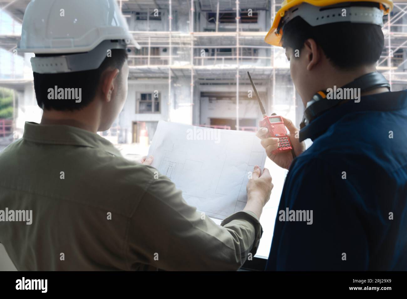 Civil engineers and architects inspecting and working building site ...