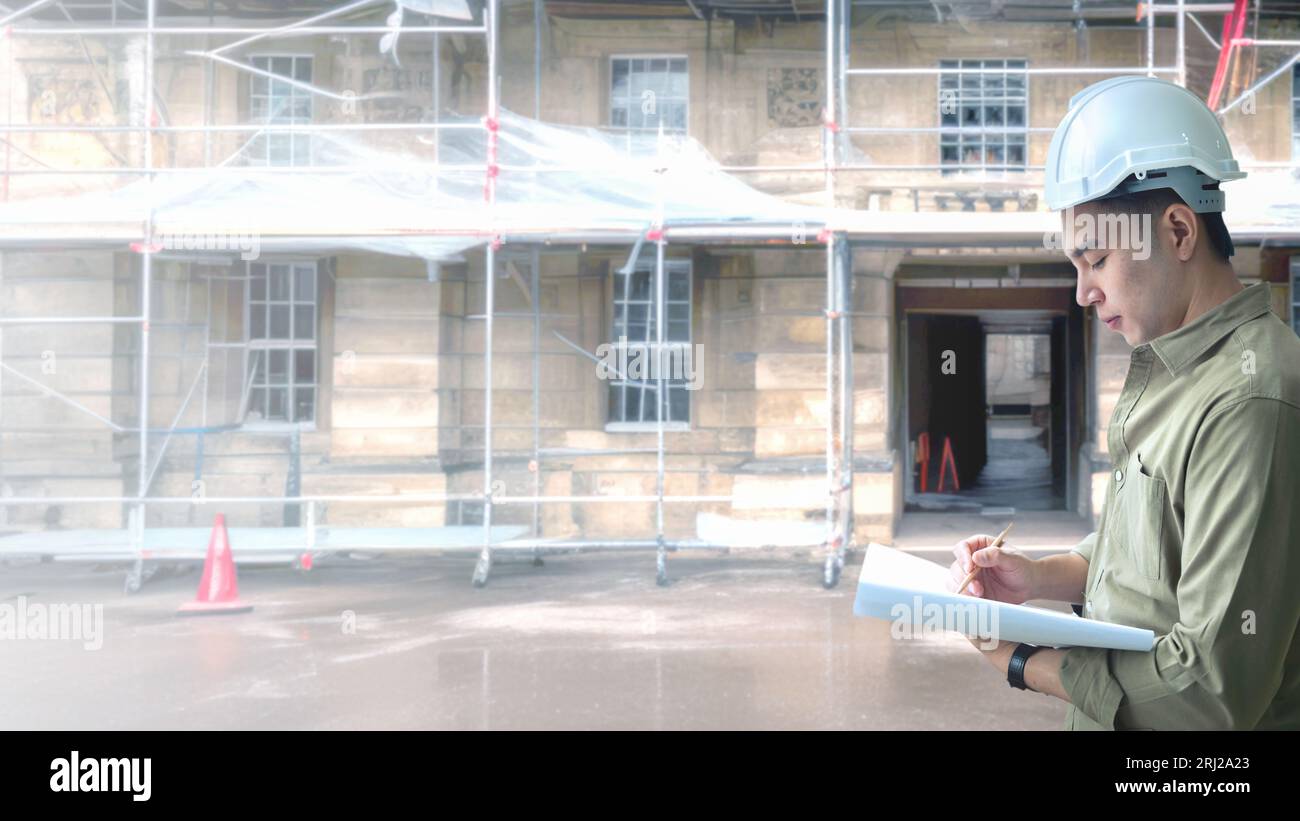 The inspector or engineer is checking the building structure and house ...