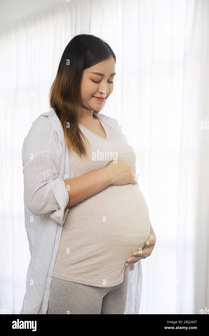 pregnancy woman hugging her tummy and feel happy with big belly at ...