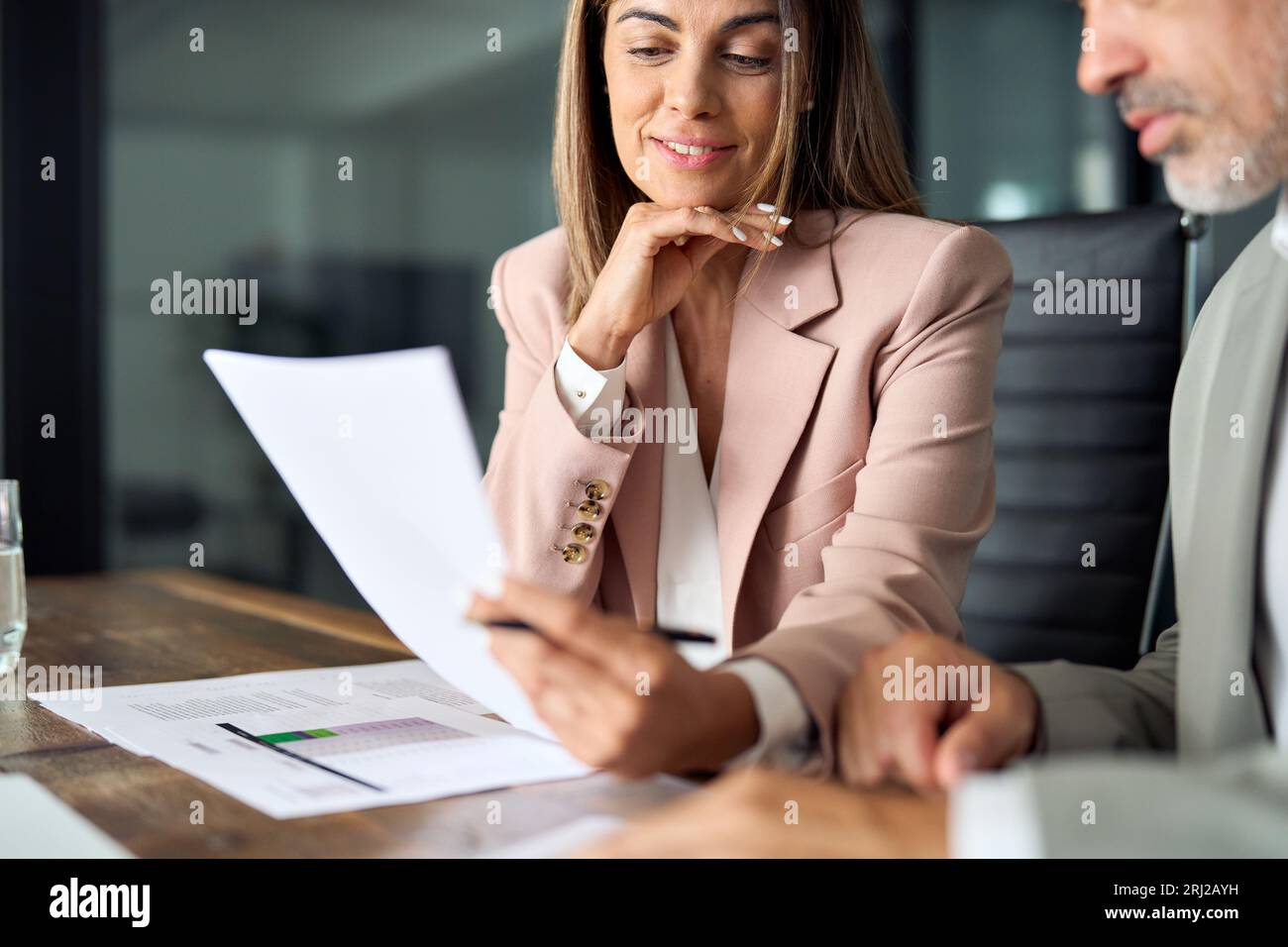 Lawyer showing document to client providing legal consultancy services ...