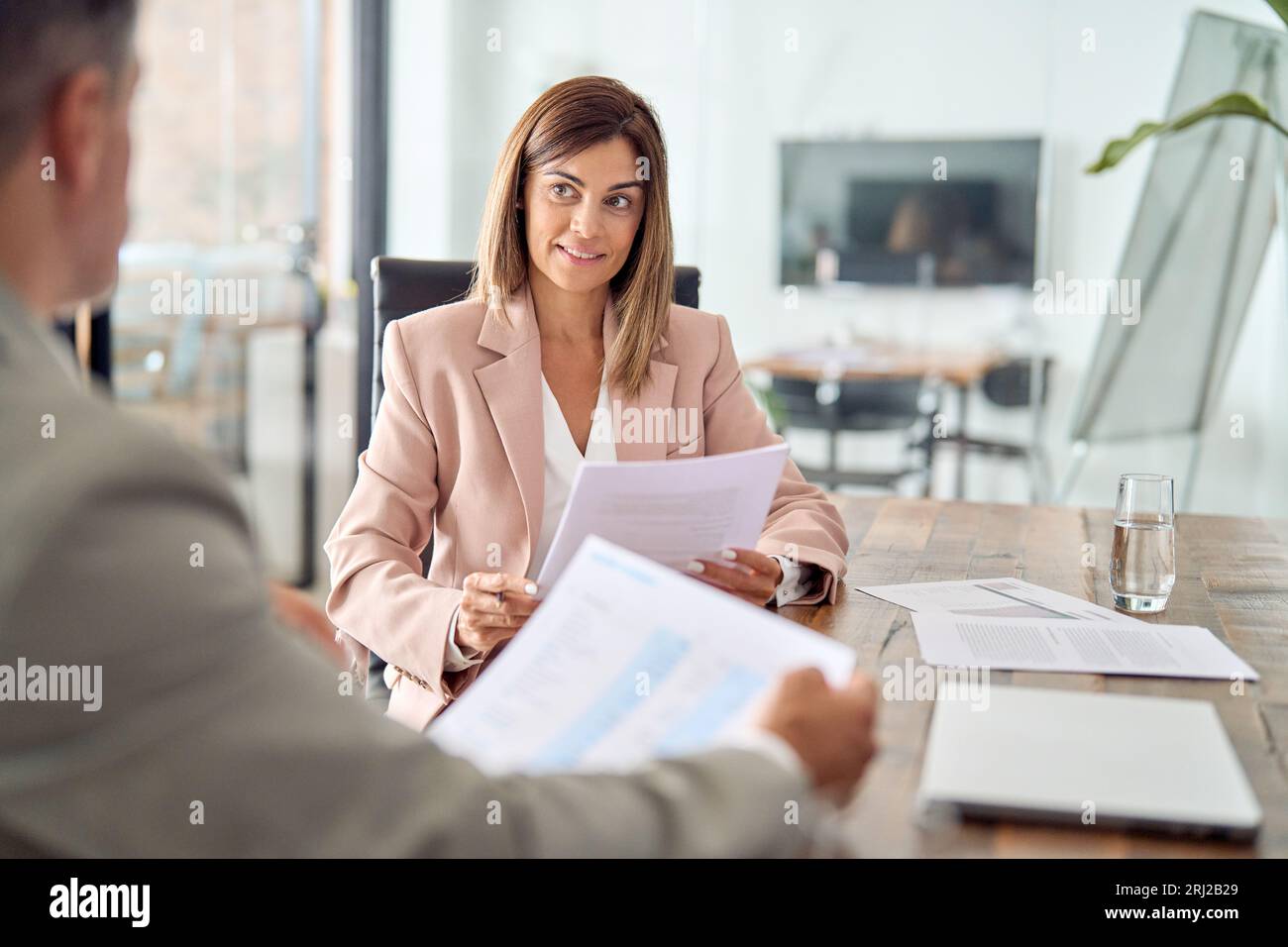 Mature business woman manager discussing documents at office meeting ...