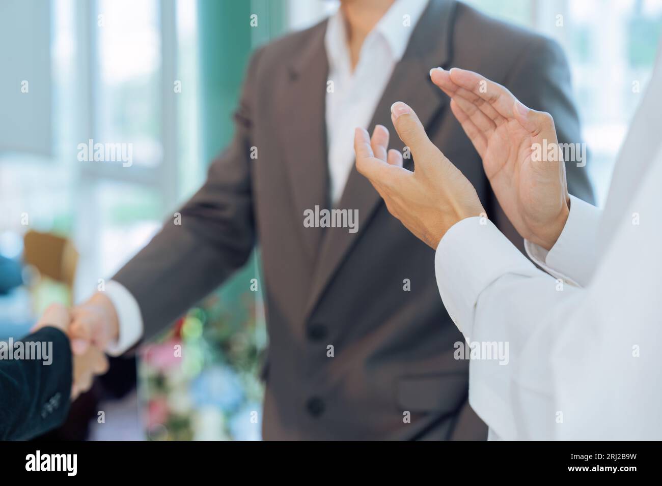 colleagues clapping hands while professional successful businesspeople ...