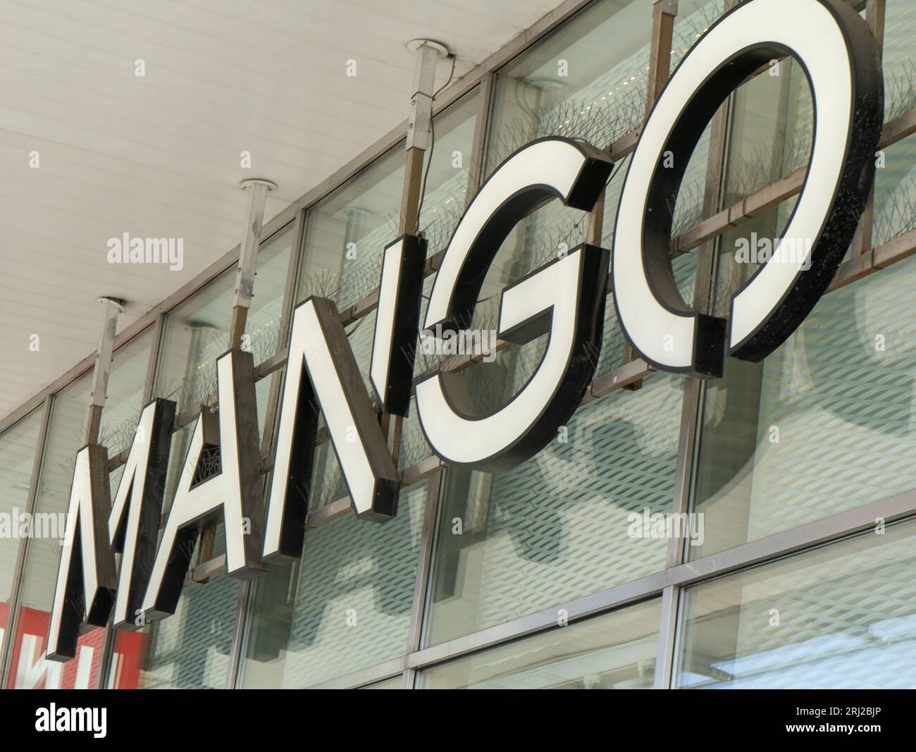 MANGO shop in Warsaw. Logo sign at the entrance. Signboard on street ...