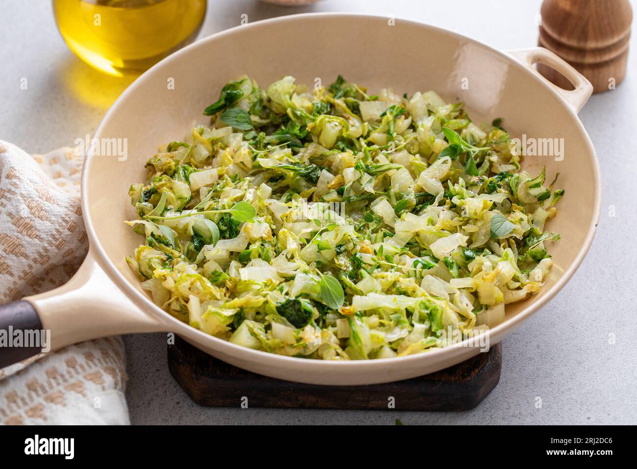 Sauteed cabbage with herbs in a cast iron pan, healthy vegetable side ...