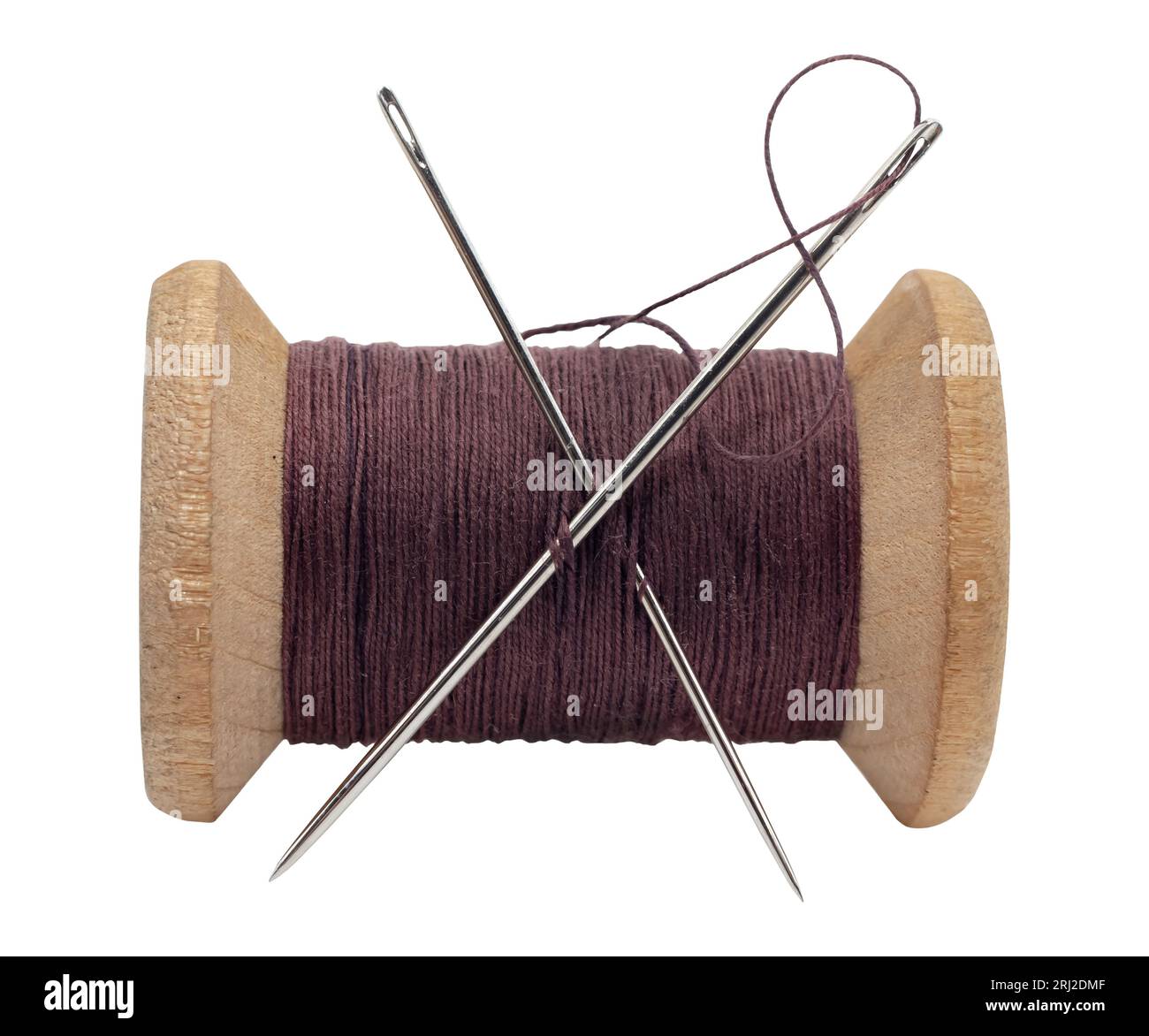 Old wooden spool of thread and needle on a white background. Sewing ...