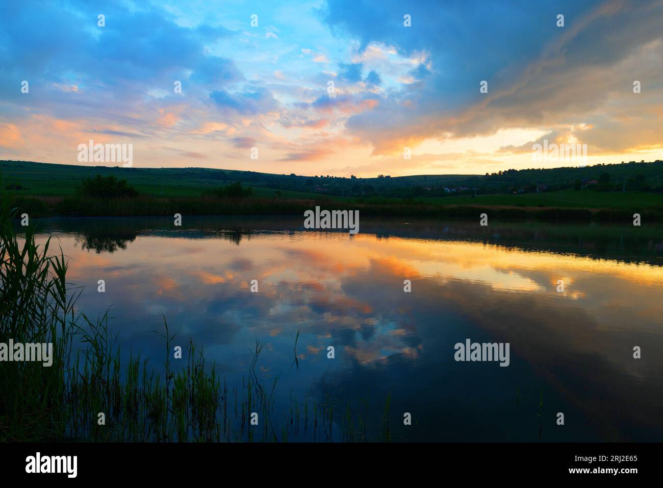 beautiful sunset over the lake, orange and blue colors of dawn Stock ...