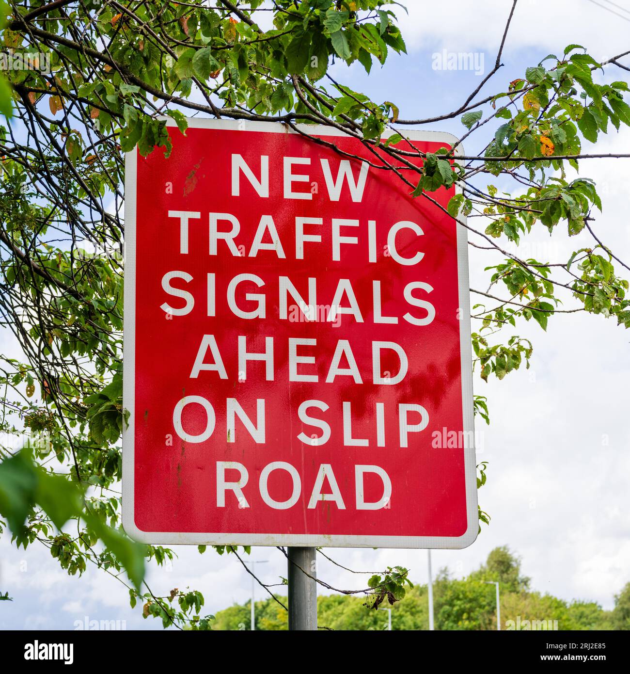 New traffic signals ahead on the slip road, red warning sign warning ...