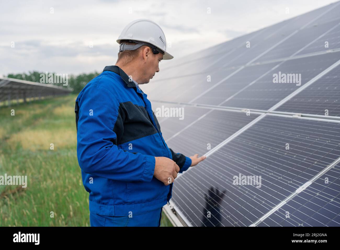 Service Engineer man touching solar panels. Technician maintenance ...