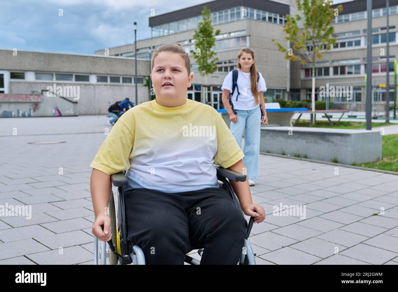 Children go to school, disabled boy 11, 12 years old on a wheelchair ...