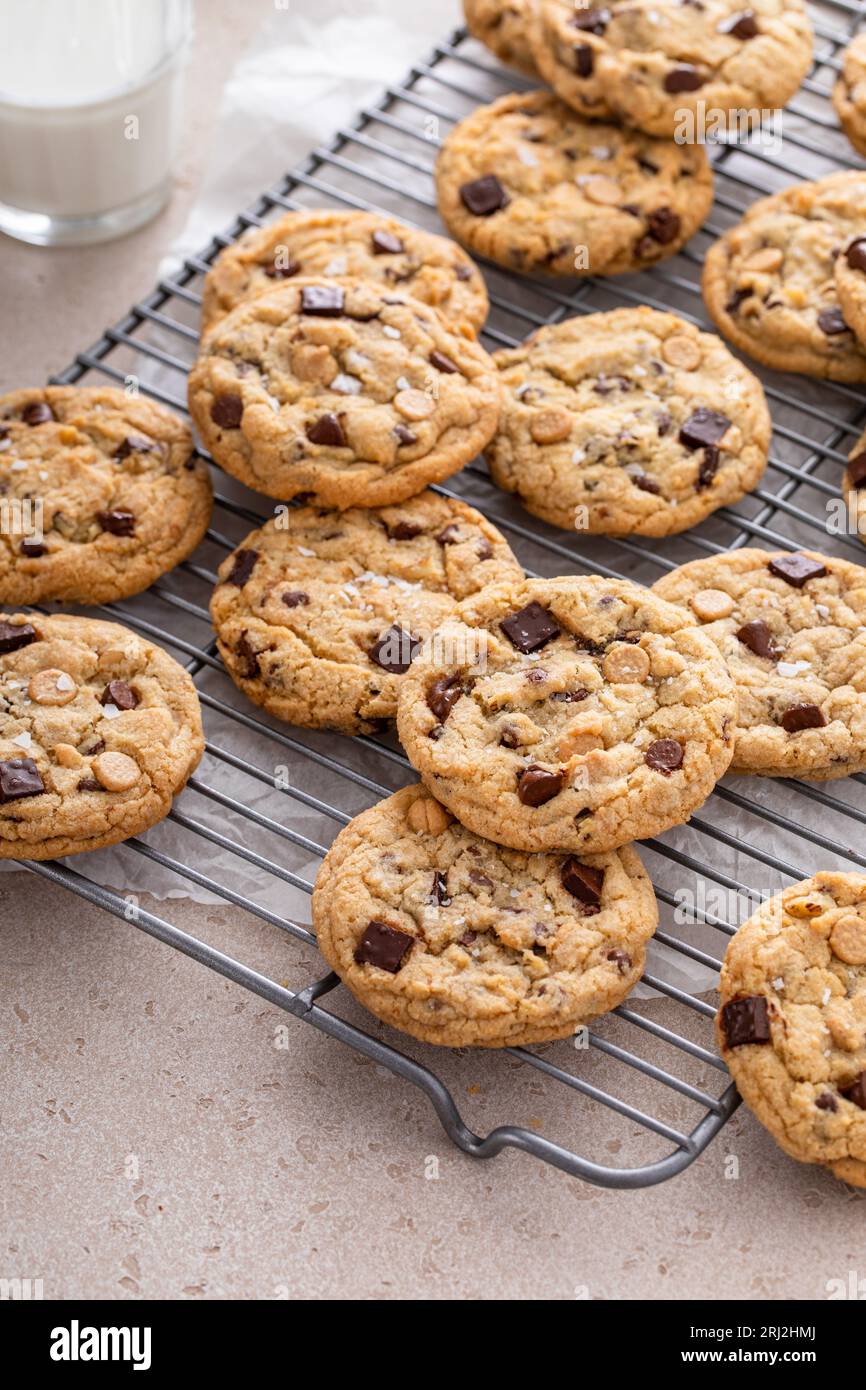 Chocolate chip cookies on a cooling rack with flaky salt served with ...