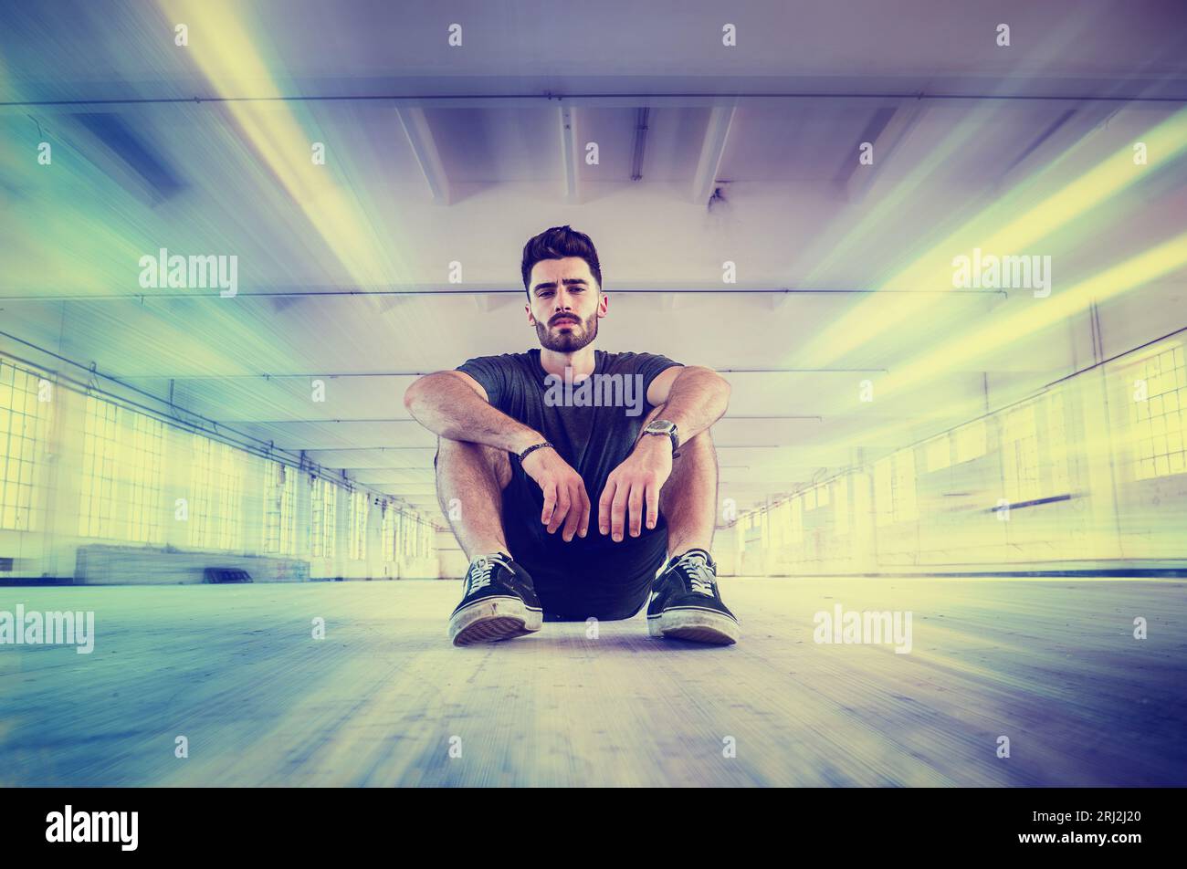 Photo of a man sitting on the floor with his legs crossed Stock Photo ...