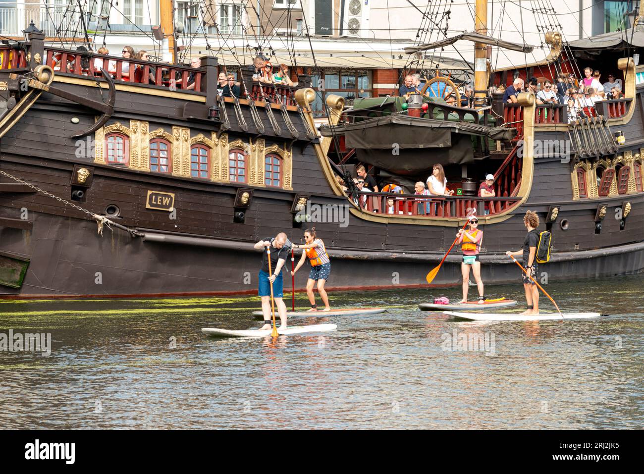 Paddleboarding in Gdansk. People on paddleboards passing by the Lew ...