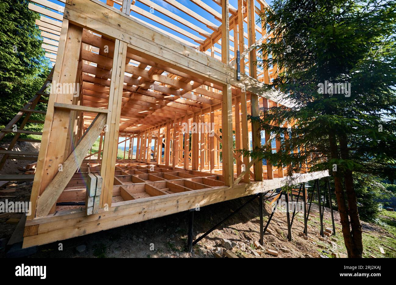 Residential building with wooden frame in process of being built near a ...