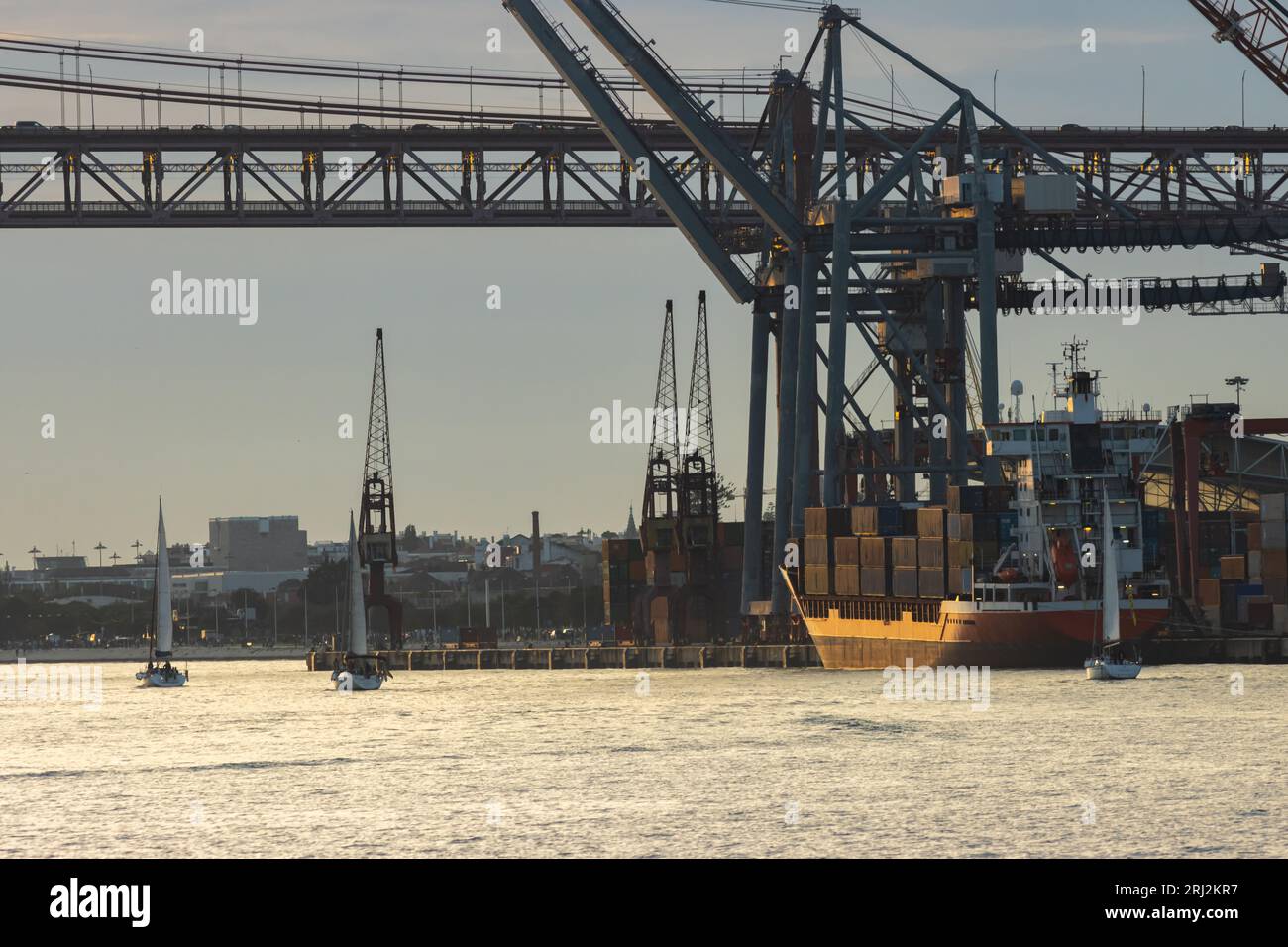 A cargo ship stands at the seaport in early evening. Mid shot Stock ...