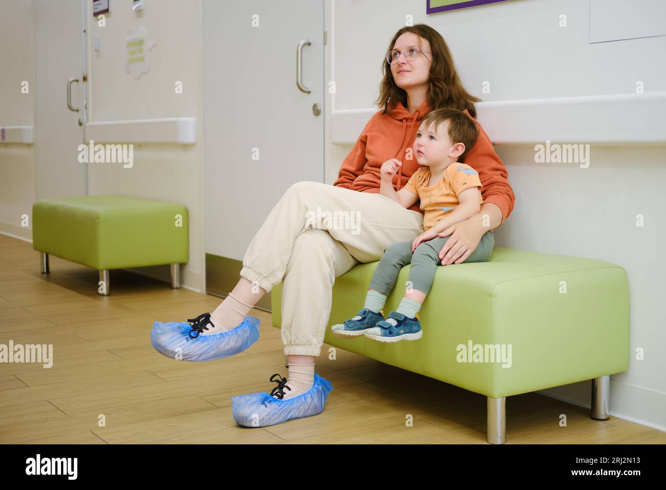 The woman and her child are in the medical waiting room as they wait ...