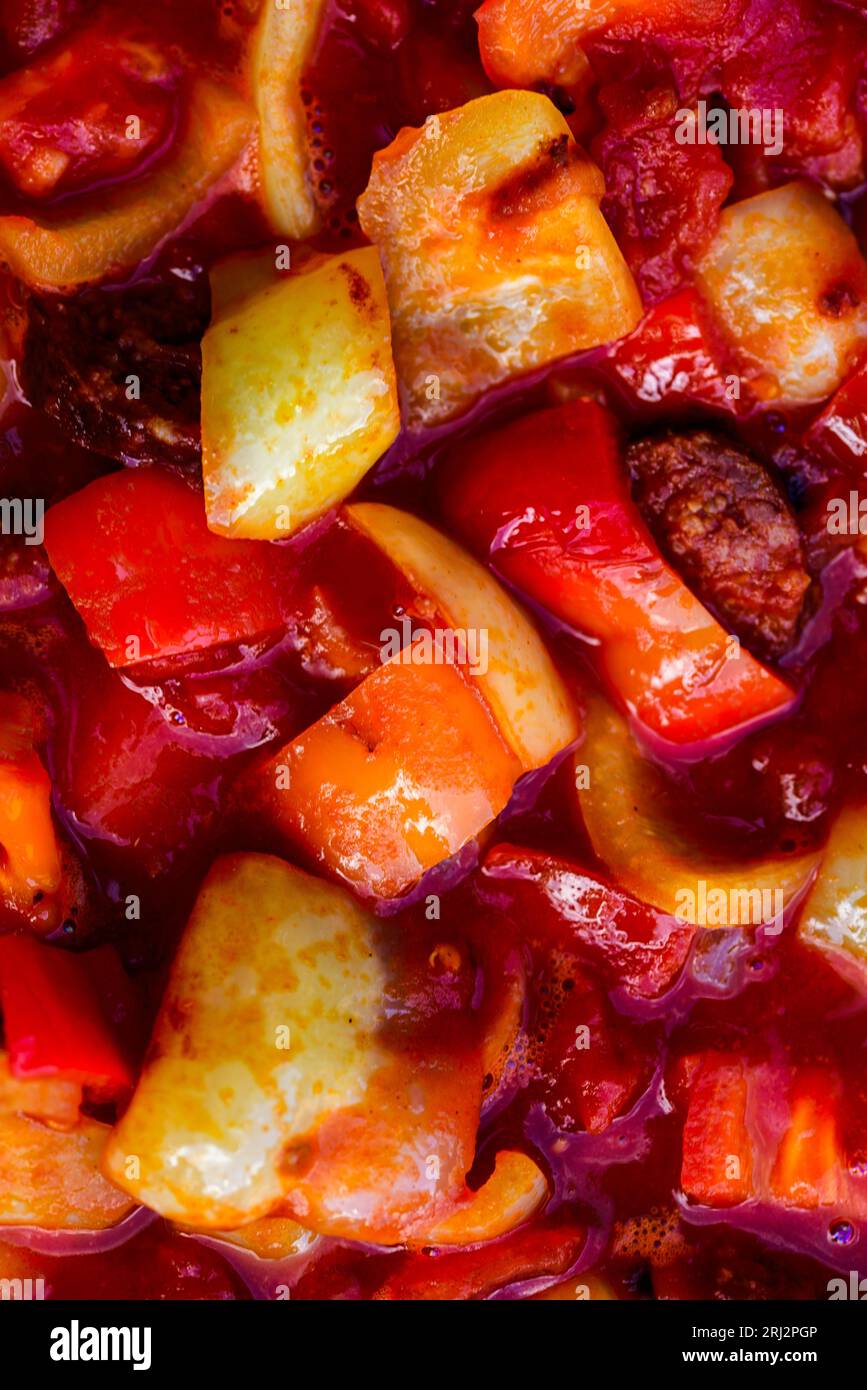 Letcho, stew with courgette and sausages. The food being cooked is ...