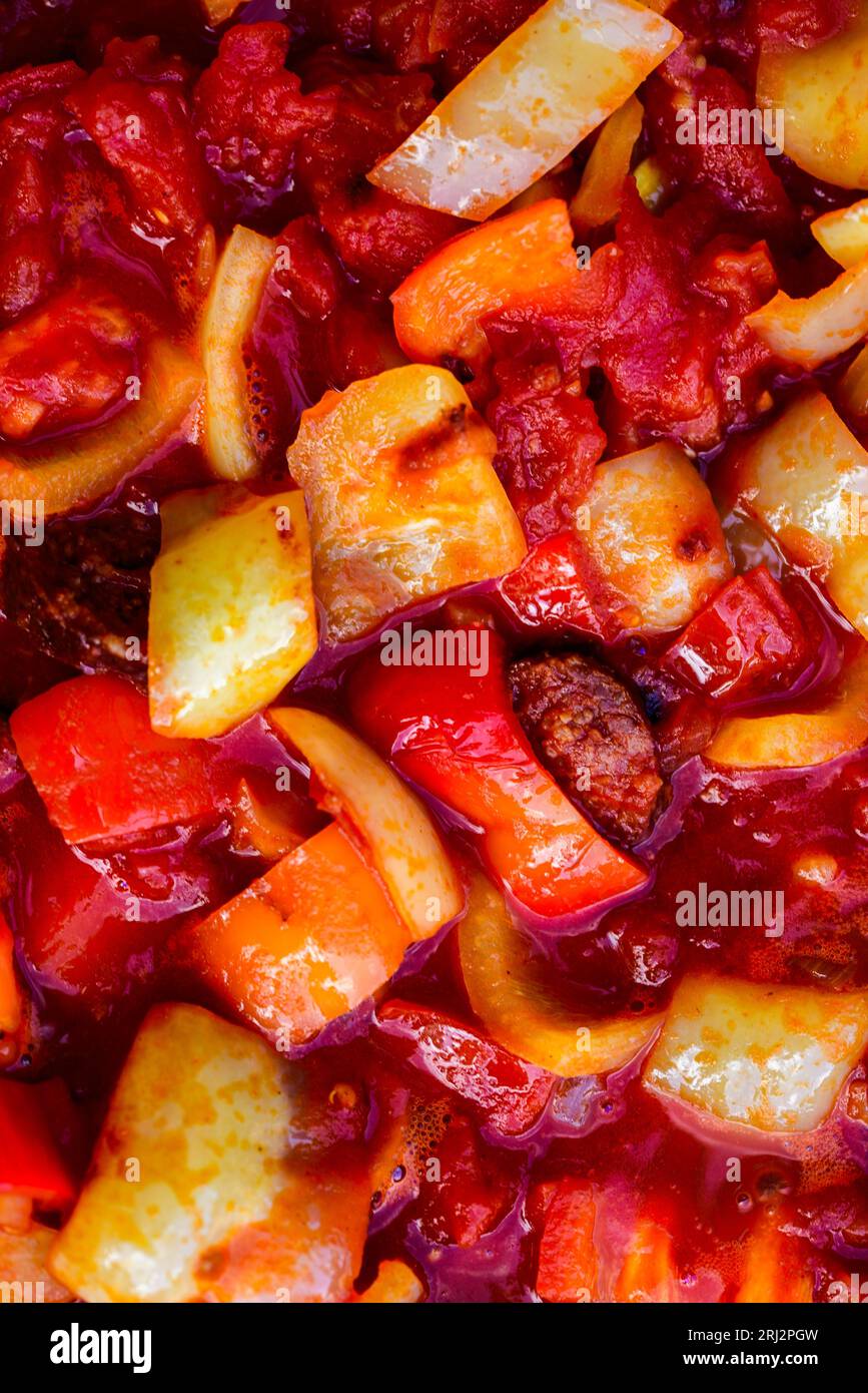 Letcho, stew with courgette and sausages. The food being cooked is ...
