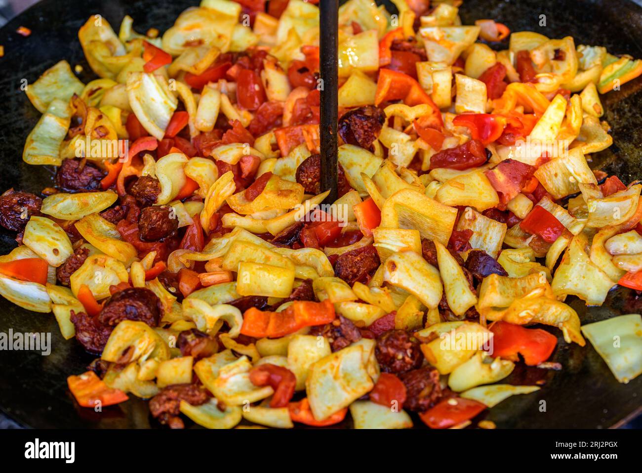 Letcho, stew with courgette and sausages. Cooking outdoors in the ...