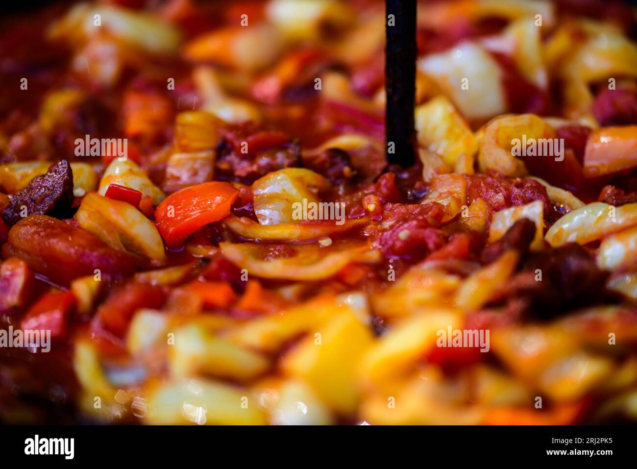 Letcho, stew with courgette and sausages. Cooking outdoors in the ...