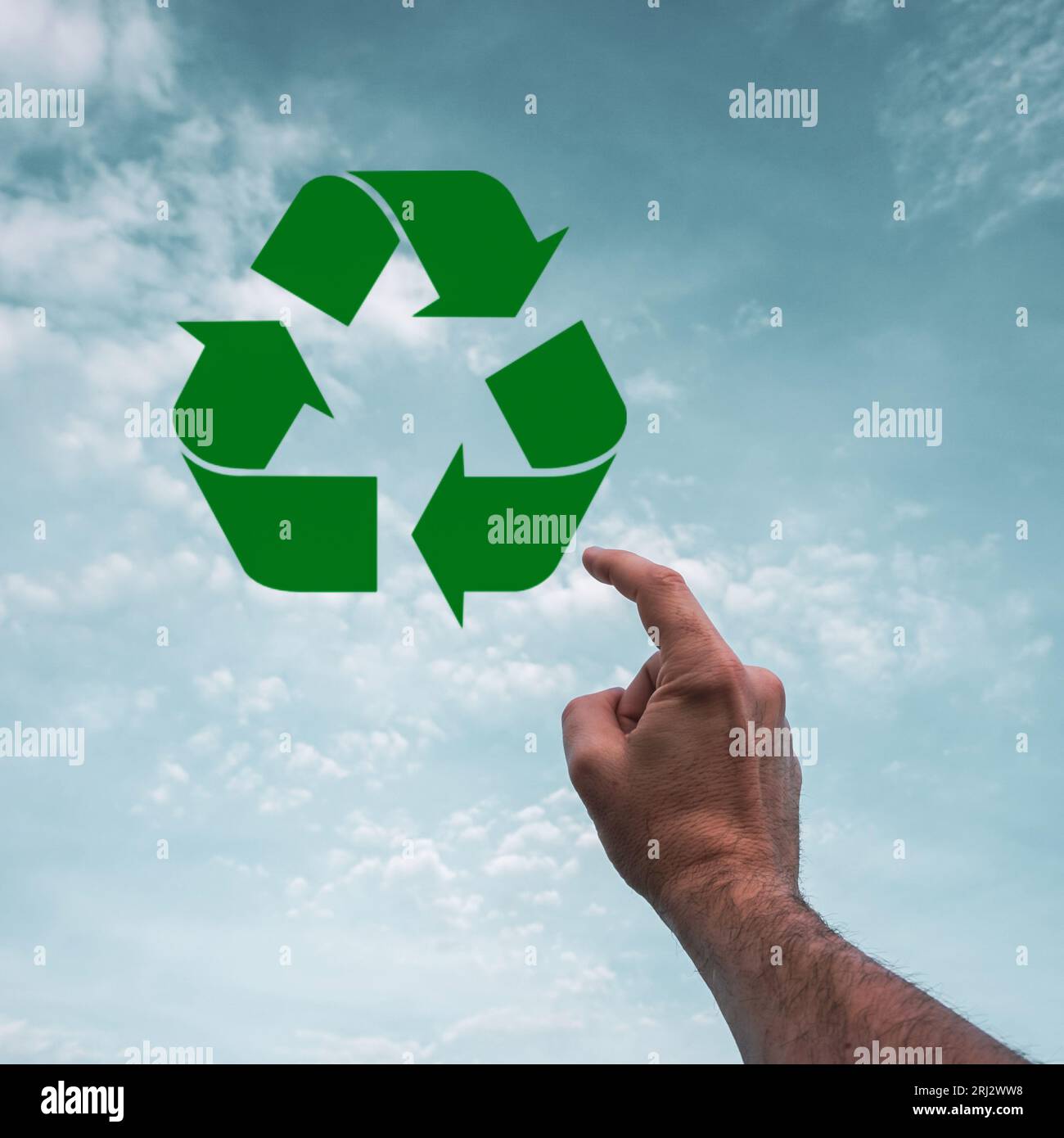 index finger pointing to the recycling symbol Stock Photo - Alamy