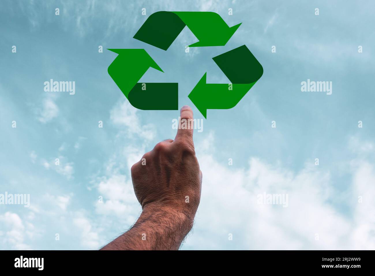 index finger pointing to the recycling symbol Stock Photo - Alamy