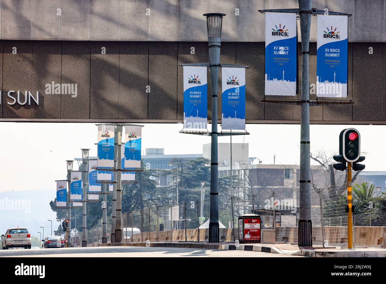 Banners advertising the 2023 BRICS summit hang on a street leading to ...