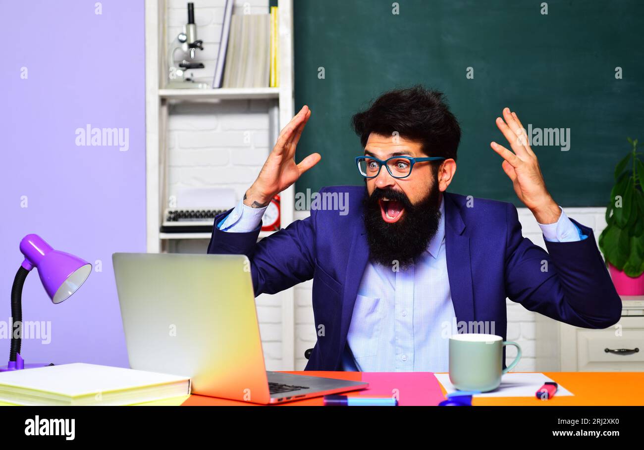 Excited male student with raised hands at classroom. Success. Happy ...